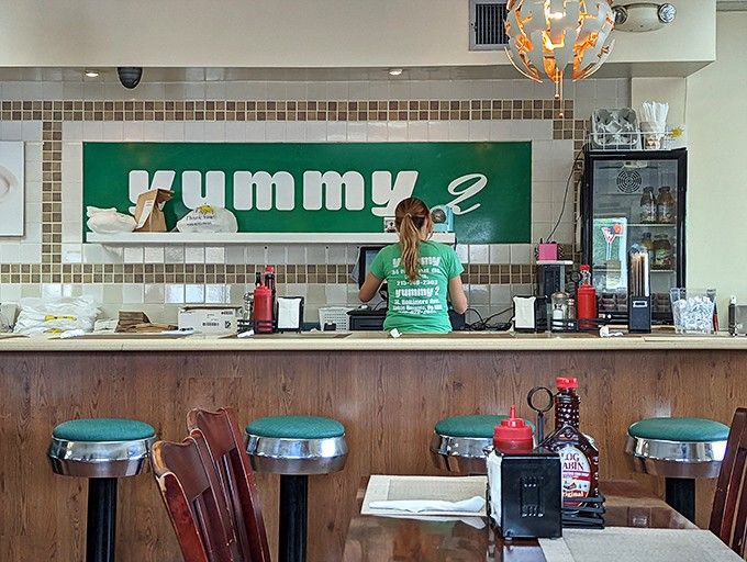 Counter seating with chrome stools facing the kitchen means you can watch breakfast magic happen in real time.