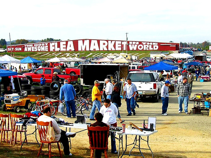Tables overflow with possibilities beside vintage tractors, creating a landscape that's part market, part outdoor museum.
