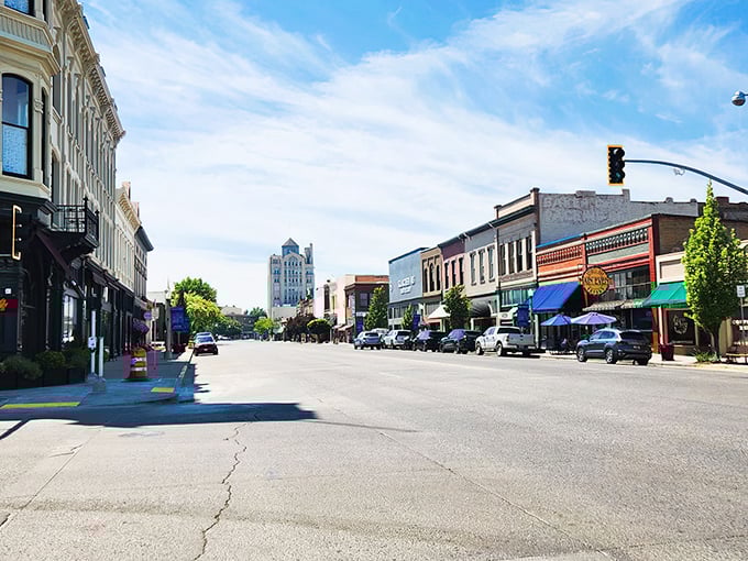 Baker City's historic Main Street stretches toward the horizon, where brick buildings and blue skies create the perfect small-town movie backdrop.
