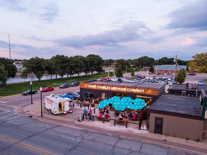 Charles City's riverside brewery isn't just serving craft beer&mdash;it's brewing community connections under those cheerful blue umbrellas.