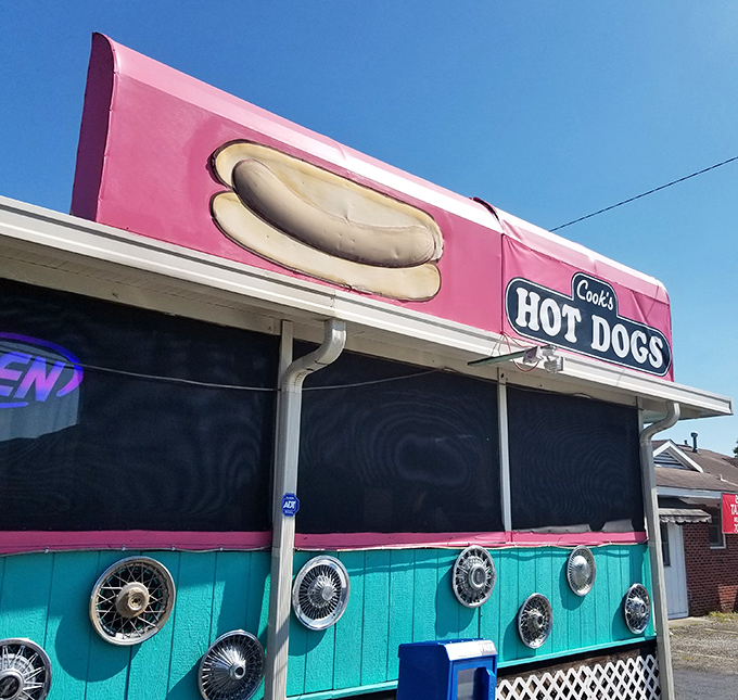 Pink and turquoise with chrome wheels - this place celebrates the joy of hot dogs with pure artistic flair.