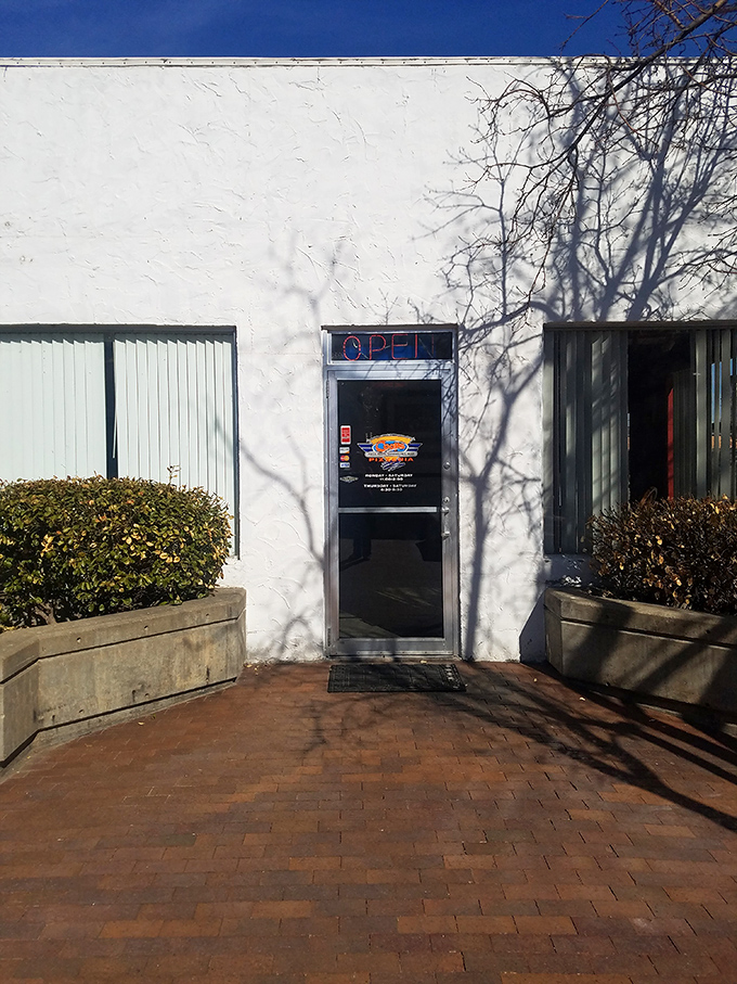Coop's bright red awning stands out like a pizza oasis in Salina. Your hunger's final destination!