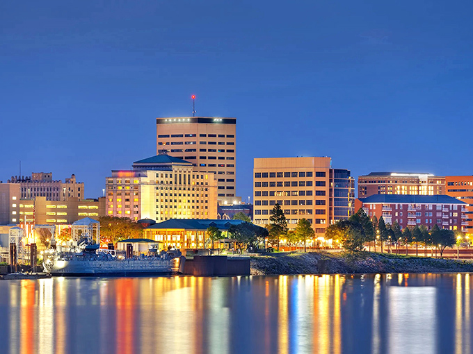 Evansville's skyline glows at dusk along the Ohio River, reflecting both city lights and budget-friendly living options.