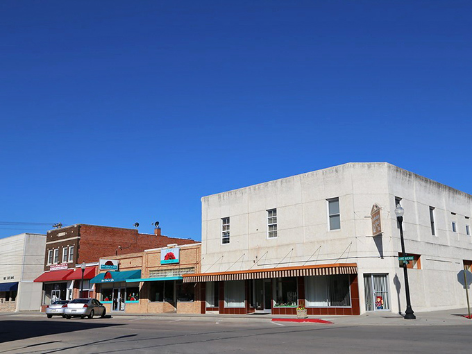 Pristine brick storefronts showcase small-town pride where every building maintains its historic character perfectly.