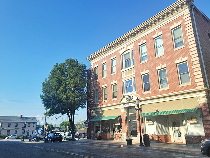 Classic brick buildings line this charming street where every storefront tells a story of community resilience.