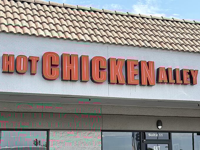 Hot Chicken Alley's bold orange signage is your first warning: serious Nashville heat has landed in Phoenix.