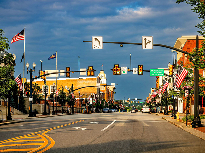 Stars and stripes wave proudly over this all-American main street that could be Hometown, USA in any movie.