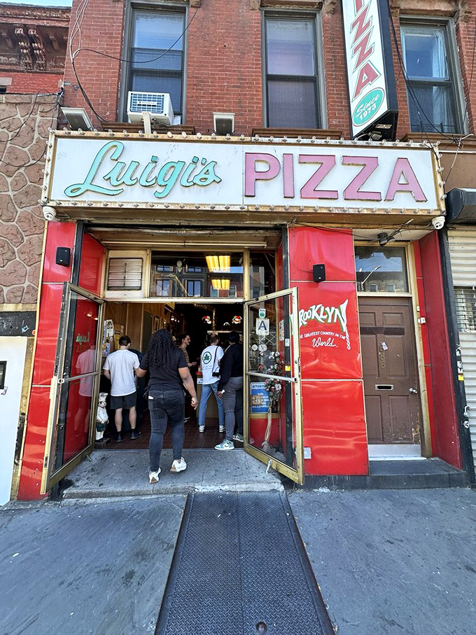 Luigi's vintage sign promises pizza authenticity that Brooklyn has perfected over countless delicious decades.