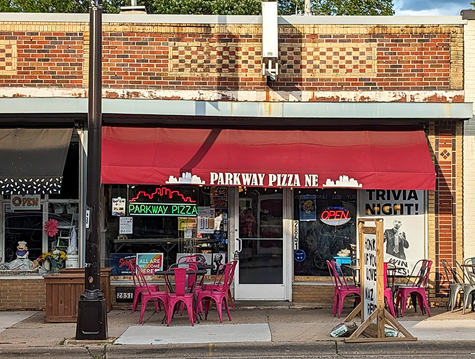 The bright red awning and colorful outdoor seating announce a pizza place that's serious about flavor but doesn't take itself too seriously.
