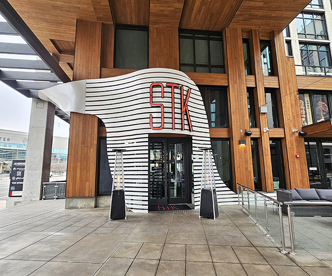 STK's entrance is architectural drama at its finest. The steakhouse that studied modern art before culinary school.