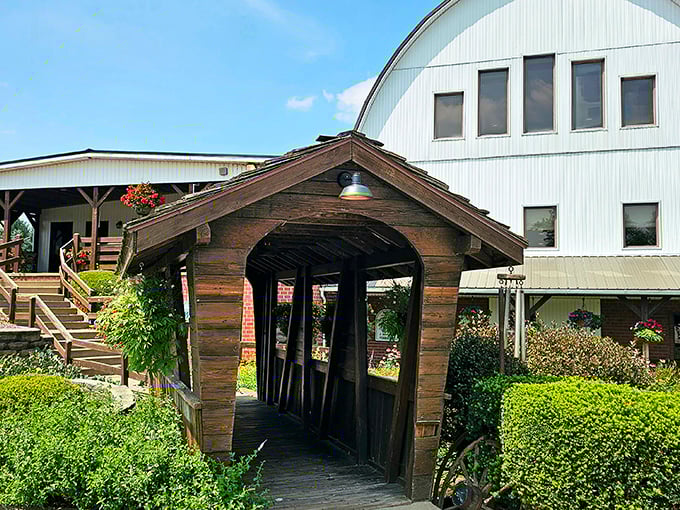 The Barn Restaurant's rustic covered bridge entrance promises an authentic dining experience steeped in country charm and tradition.