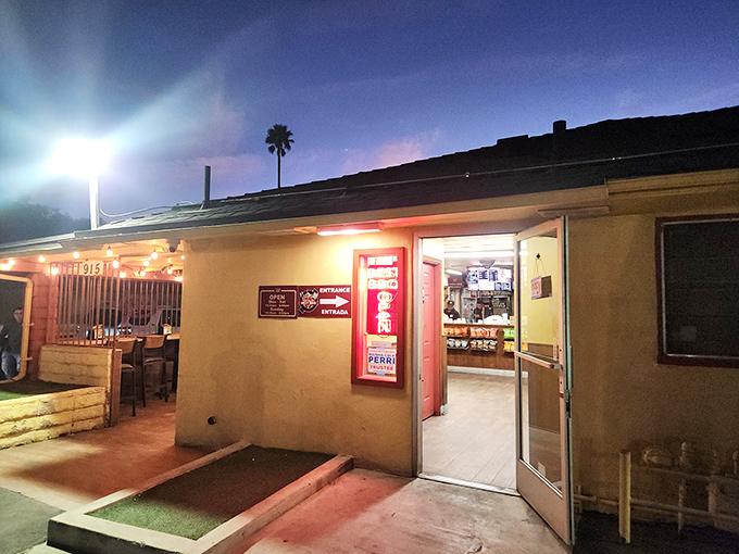 Night falls but the smoker's still going! Best Bar-BQ's simple storefront transforms into a beacon for hungry travelers as evening arrives.