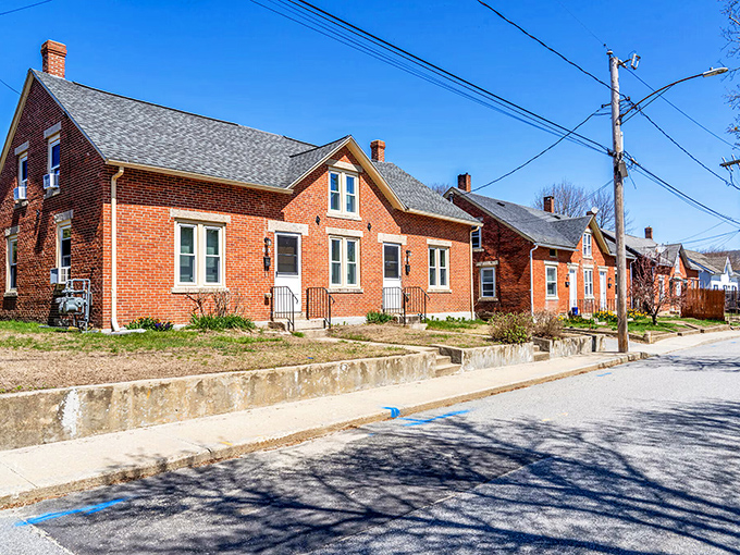 Historic brick homes line a quiet street in Brooklyn, showcasing the affordable housing options with character that make these Connecticut towns so appealing.