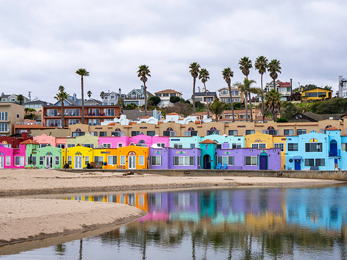 Colorful cottages reflect in calm waters where this vintage beach village shows off its playful seaside personality.