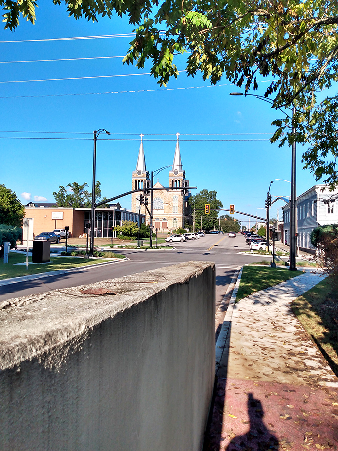 Twin church spires reach skyward, blessing a community where retirement budgets stretch like Sunday sermons.