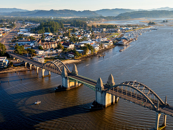 The Siuslaw River Bridge's Art Deco elegance perfectly frames this charming riverside town's historic waterfront district.