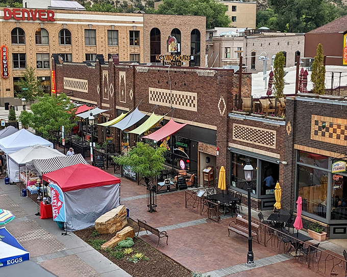 The bustling marketplace in Glenwood Springs invites visitors to shop, dine, and people-watch under colorful canopies.