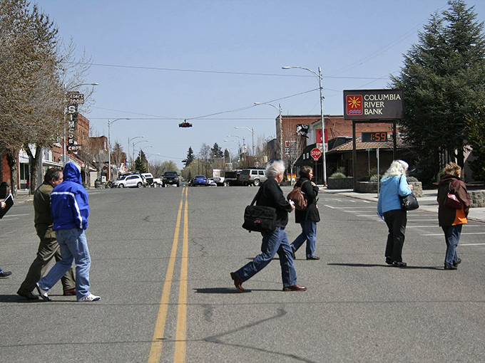 Pedestrians cross Goldendale's main street while Columbia River Bank's clock ensures nobody's rushing through paradise.