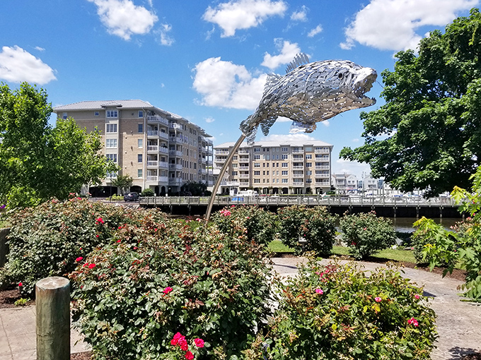 That magnificent fish sculpture leaps above blooming gardens, proving art and nature make perfect retirement companions.