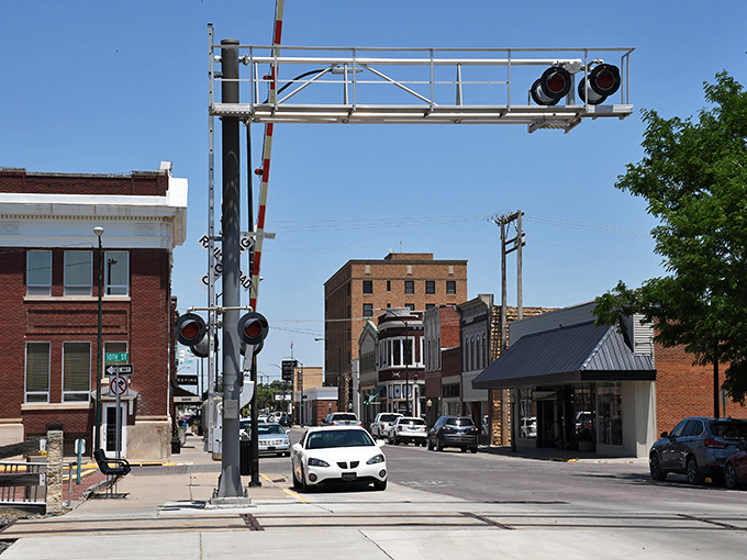 Railroad crossing signals mark a town where trains still matter and prices still make sense for hardworking families and students.