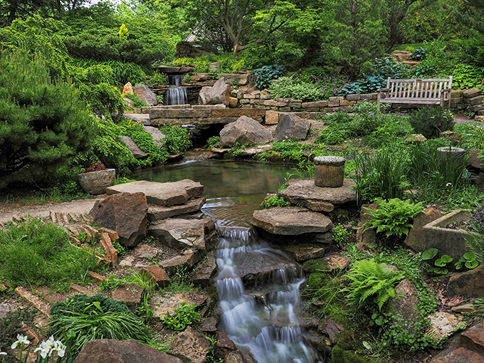 Nature's perfect waterfall moment at Inniswood Gardens &ndash; where every stone and plant seems placed by a master artist.