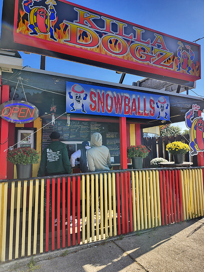 The vibrant storefront of Killa Dogz serves both hot dogs and snowballs &ndash; a one-stop shop for all your summer cravings.