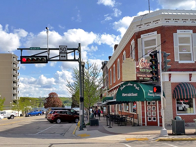 Corner caf&eacute; culture! Lake Geneva's brick-and-awning ensemble plays host to morning coffee rituals where locals and tourists mingle under the watchful eye of that traffic light.