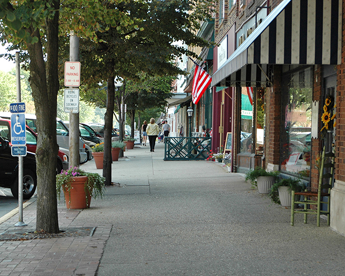 Pedestrians enjoy Lebanon's wide sidewalks, where potted plants and benches invite visitors to slow down and enjoy the historic atmosphere.