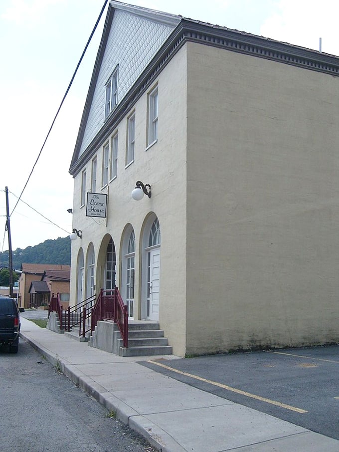 Marlinton's cream-colored historic building with elegant arched windows stands quietly dignified. The Opera House sign hints at cultural treasures inside, like finding Broadway in the mountains.