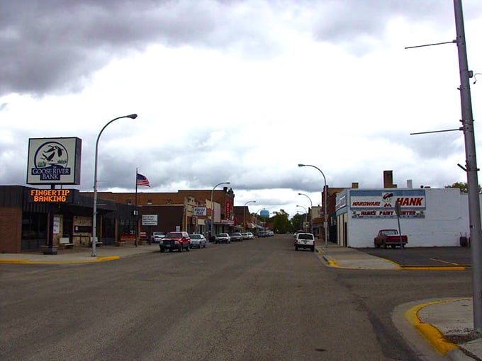 Railroad tracks run alongside grain elevators, showing how agriculture and commerce built these prairie communities from scratch.