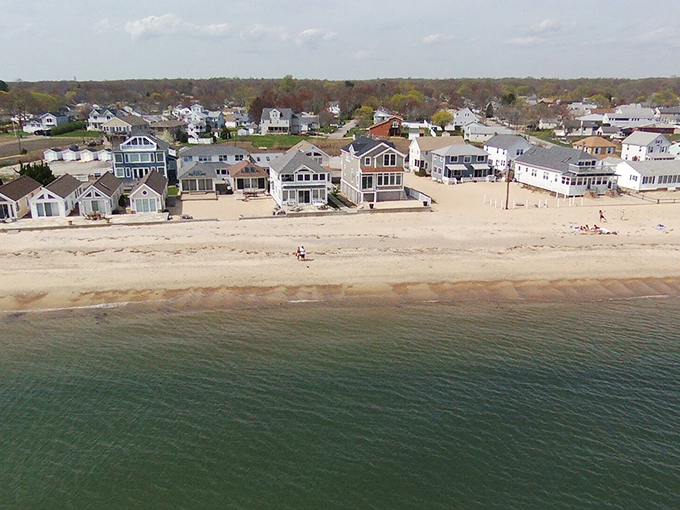 Beachfront homes lined up along pristine sand represent the Connecticut coastal dream, where history meets tide pools and summer memories.