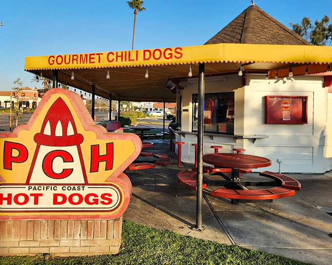 That distinctive peaked roof and outdoor seating create the perfect setting for timeless hot dog perfection.
