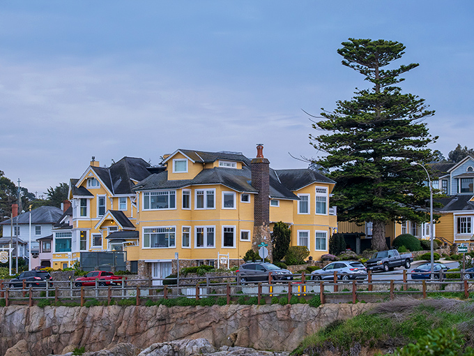 That yellow Victorian house stands like a cheerful sentinel, watching over Pacific Grove's timeless shoreline.