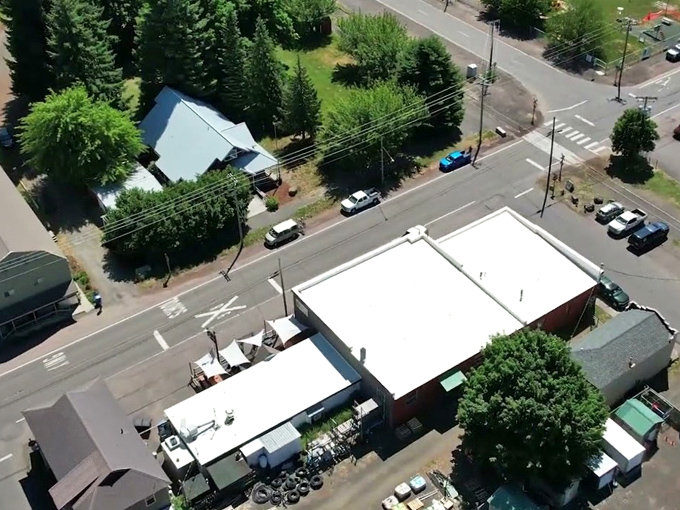 An aerial view of Parkdale reveals a quiet crossroads town framed by evergreens&mdash;small in size but surrounded by big Oregon scenery.