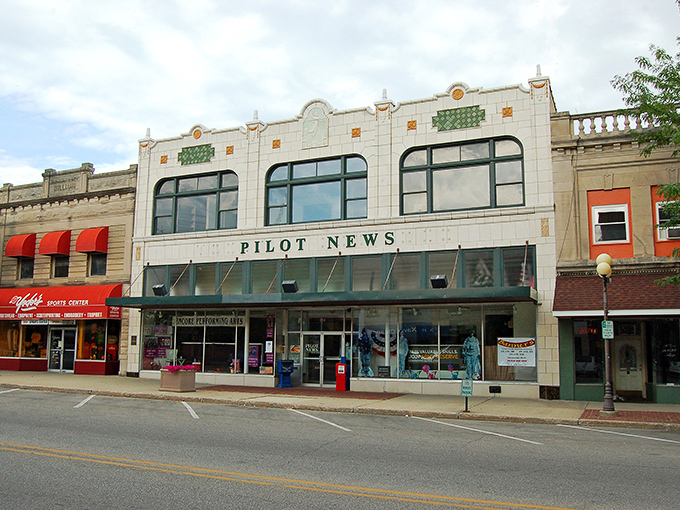 The Pilot News building anchors Plymouth's affordable main street, where retirement headlines read "Budget Breathing Room Found!"