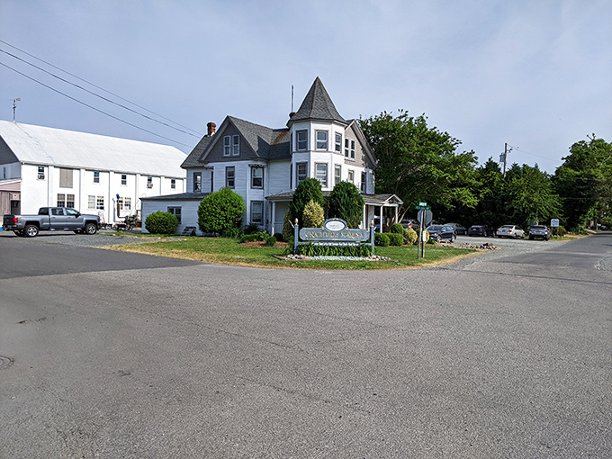White Victorian elegance stands guard over a community where water defines every daily rhythm.