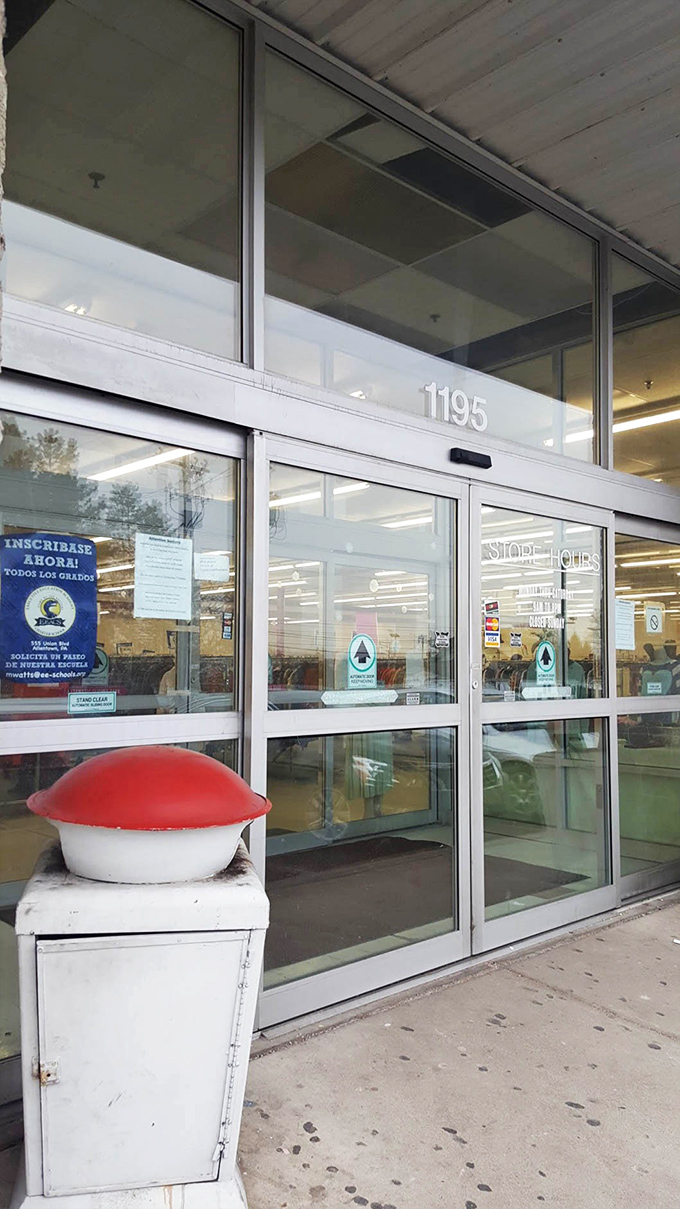 Glass doors reveal organized aisles that make thrift shopping feel surprisingly civilized and enjoyable.