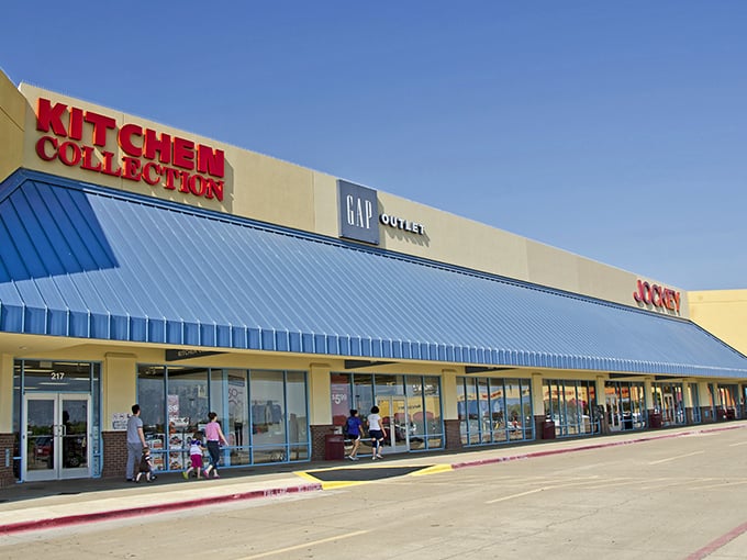 Colorful facades line up like retail soldiers, each one ready to serve up savings to smart shoppers. 