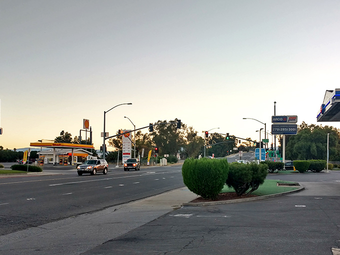 Golden hour illuminates a main street where local businesses thrive by treating customers like neighbors, not profit centers.