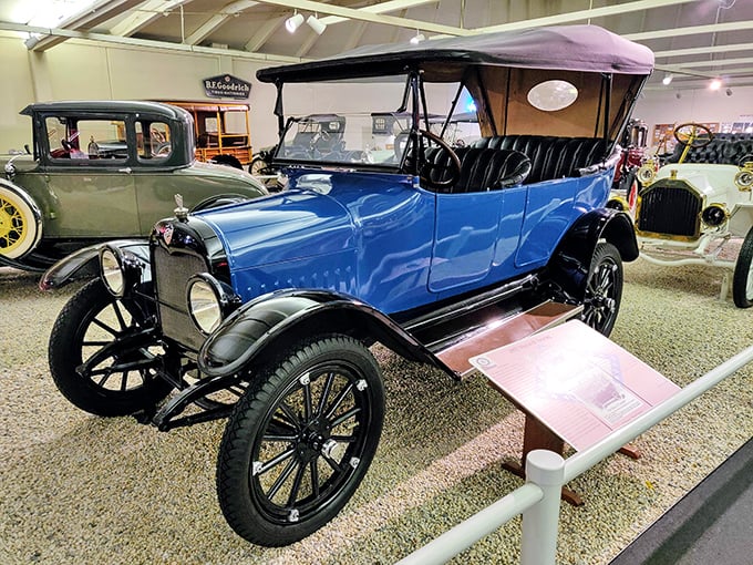 The 1915 Studebaker Model SD Touring car gleams in brilliant blue, from an era when cars were built like furniture and drove like tractors.