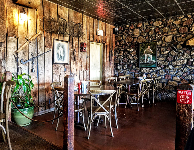 Stone walls meet wooden paneling in this dining area where "Watch Your Step" isn't just a sign &ndash; it's solid life advice.