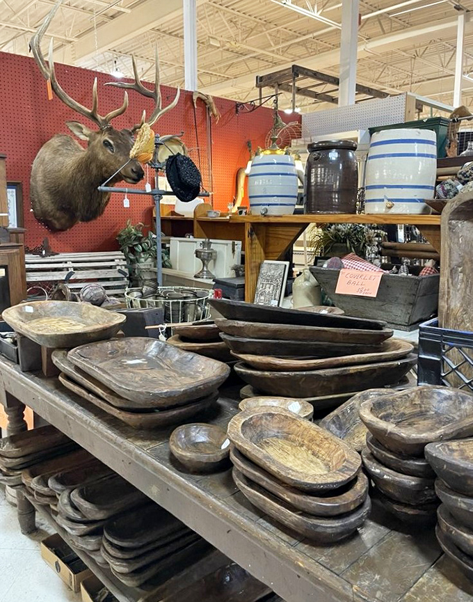 Wooden dough bowls stacked like Russian nesting dolls, while a mounted elk head supervises the proceedings with eternal vigilance and impressive antlers.