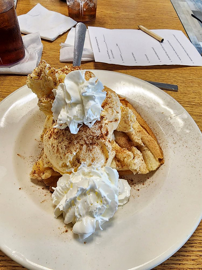 This isn't just French toast&mdash;it's a cloud of cinnamon-dusted heaven topped with enough whipped cream to make your cardiologist wince.