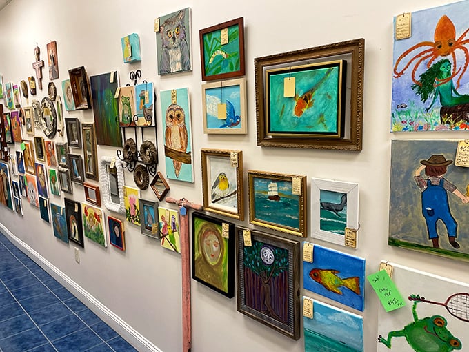 This gallery wall showcases everything from professional landscapes to what might be your neighbor's grandchild's first attempt at painting an octopus.