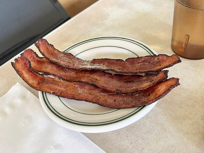 Bacon so perfectly cooked it should be in the Smithsonian. Three strips of proof that simplicity, when done right, is unbeatable.