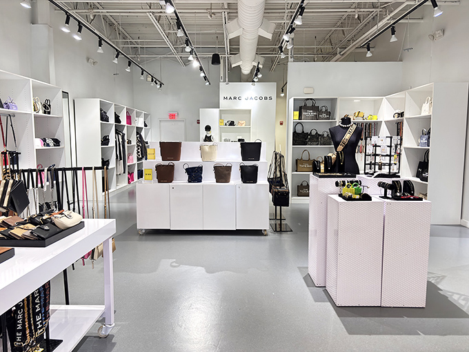 Marc Jacobs' minimalist display showcases the art of temptation. White pedestals elevate handbags from accessories to museum-worthy treasures.