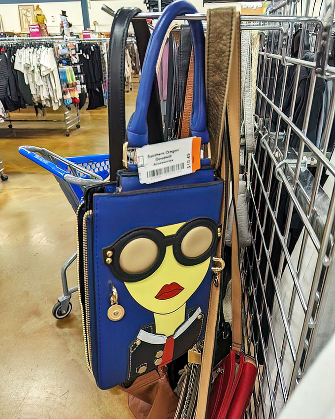 Handbags with personality hang in patient formation. That blue face purse isn't just an accessory&mdash;it's wearable art waiting for its perfect match.
