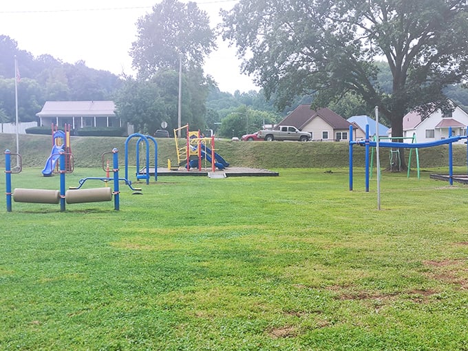 This playground stands ready for the timeless soundtrack of children's laughter. Simple equipment offering complex joy&mdash;no batteries or Wi-Fi required.