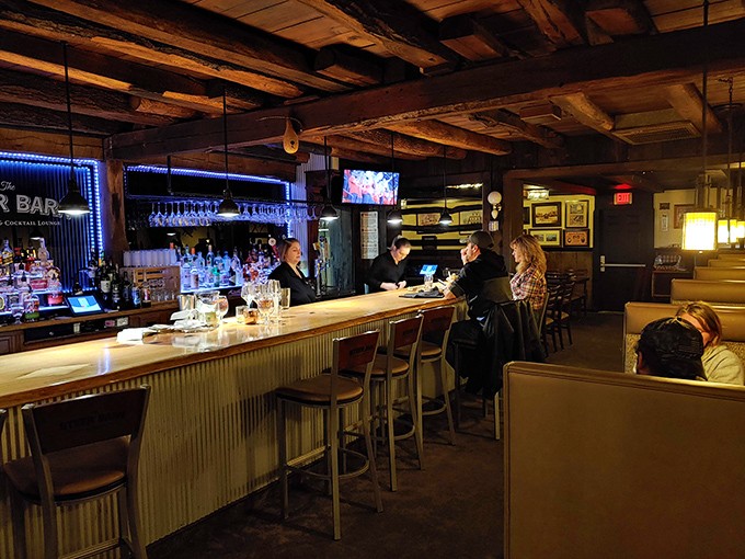 The cocktail lounge's rustic bar with its blue accent lighting creates the perfect backdrop for pre-dinner drinks or post-steak storytelling.