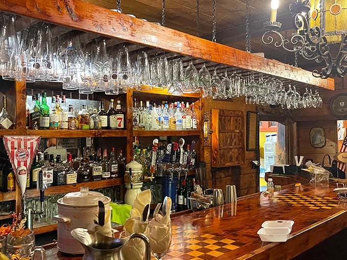 The bar gleams with hanging glassware catching the light, like crystal stalactites in a cave dedicated to the worship of German spirits.